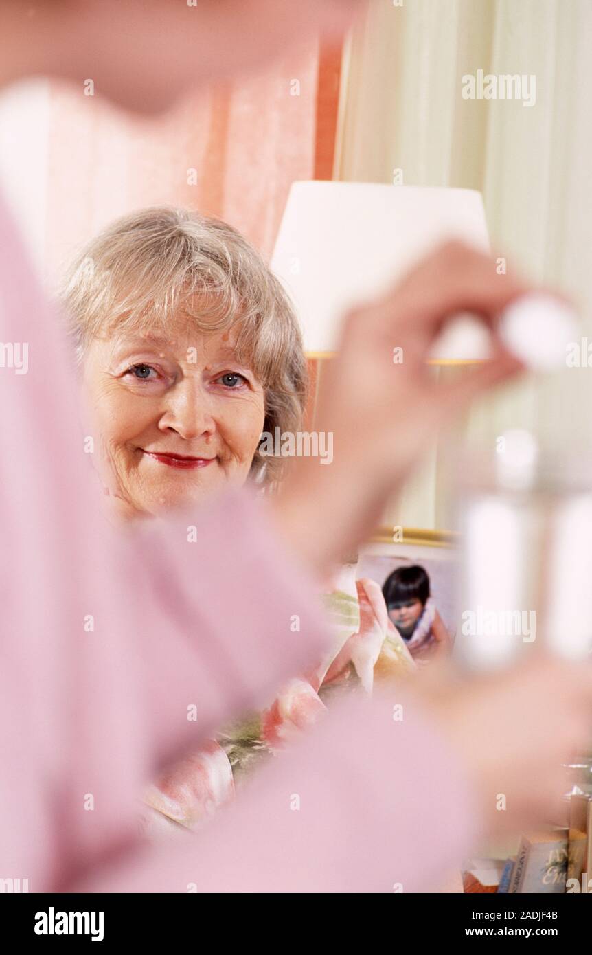Taking aspirin. Woman placing a tablet of the painkilling (analgesic ...