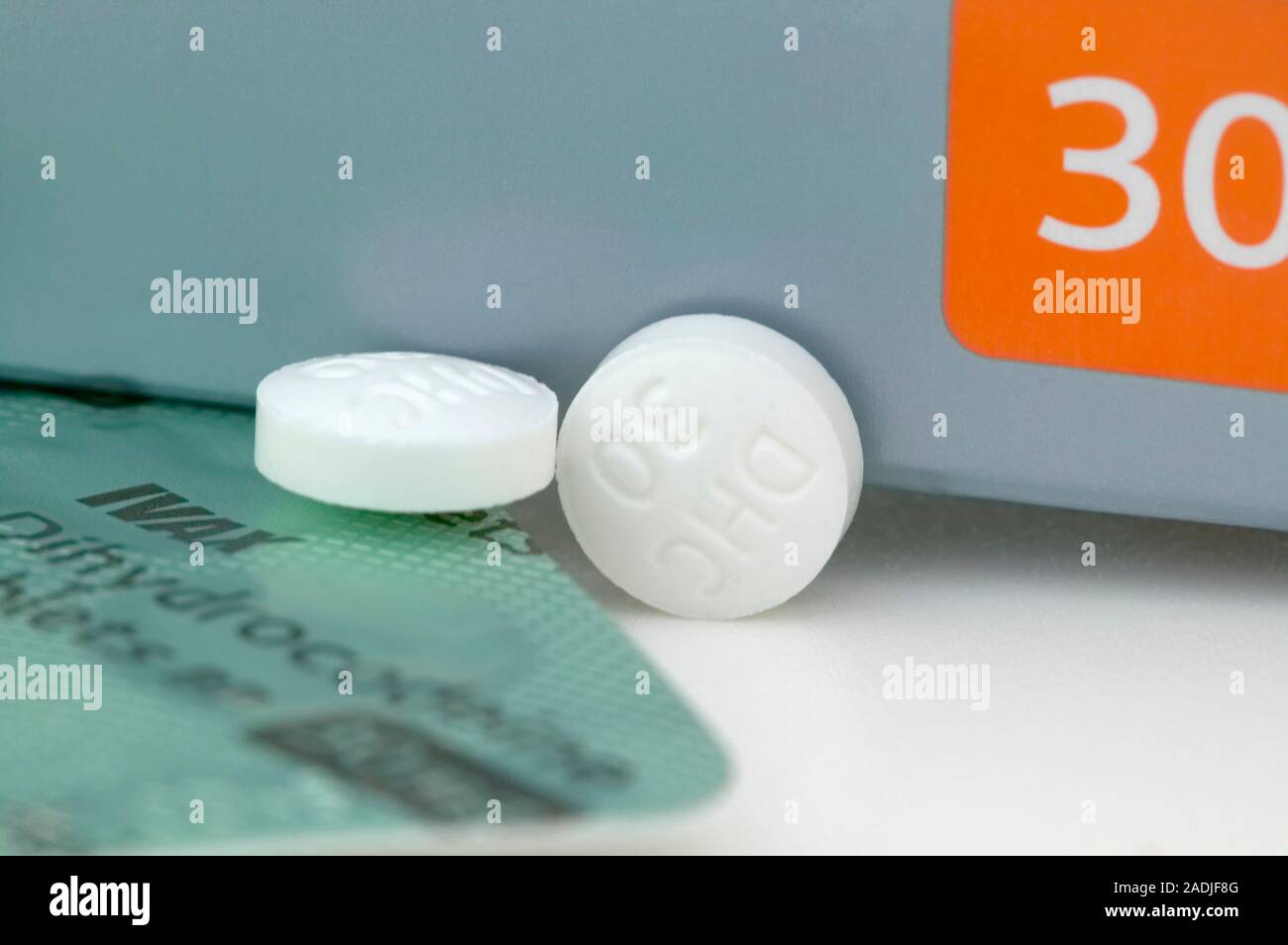 Dihydrocodeine tablets next to their packaging. This analgesic ...