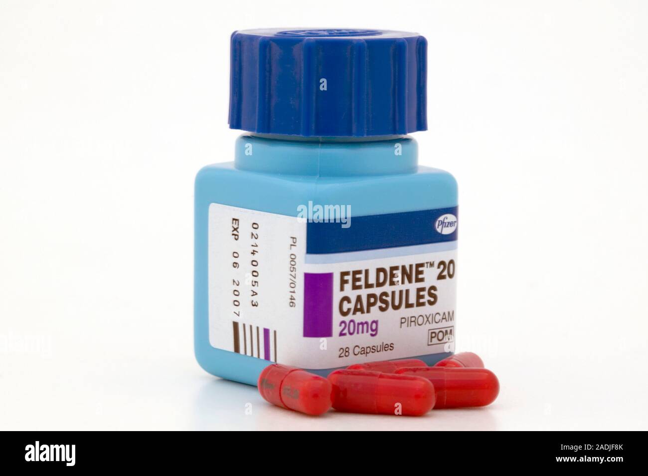 Feldene drug capsules next to their bottle. Feldene is a brand name for ...