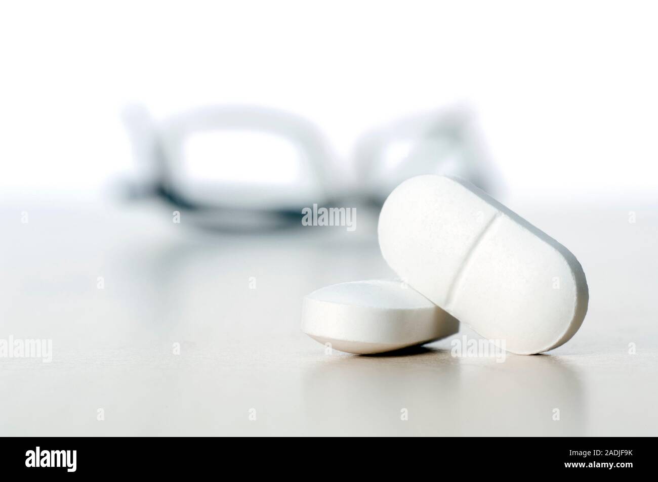 Paracetamol pills, with spectacles in the background. Paracetamol, also ...