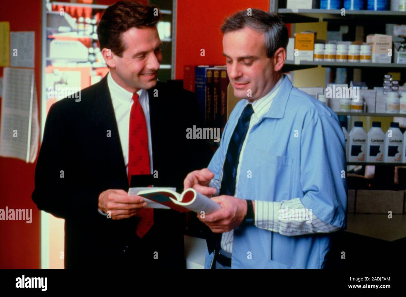 Pharmacist and salesman. View of a pharmacist (right) talking to a ...