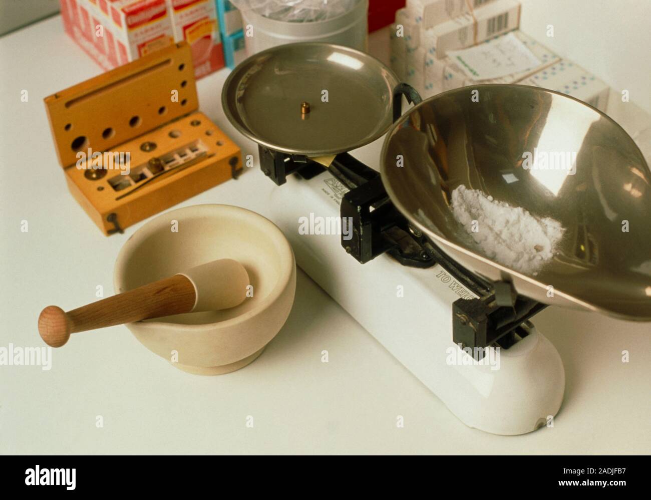 Drug prescription. Drug powder being weighed during the preparation of ...