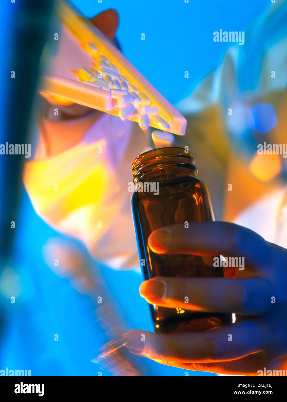 Dispensing pills. Hand of a pharmacist holds a white tray used to count ...