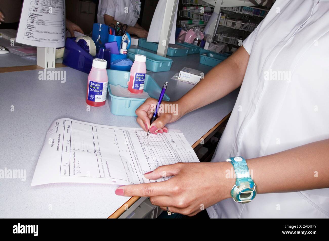 Hospital prescription. Pharmacist in a hospital pharmacy checking a ...