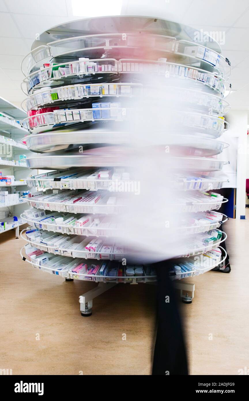 Medicine carousel. Pharmacist looking for drugs on a medicine carousel ...