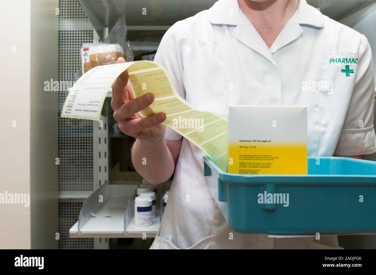 Drugs labels. Pharmacist in a hospital pharmacy checking the labels for ...