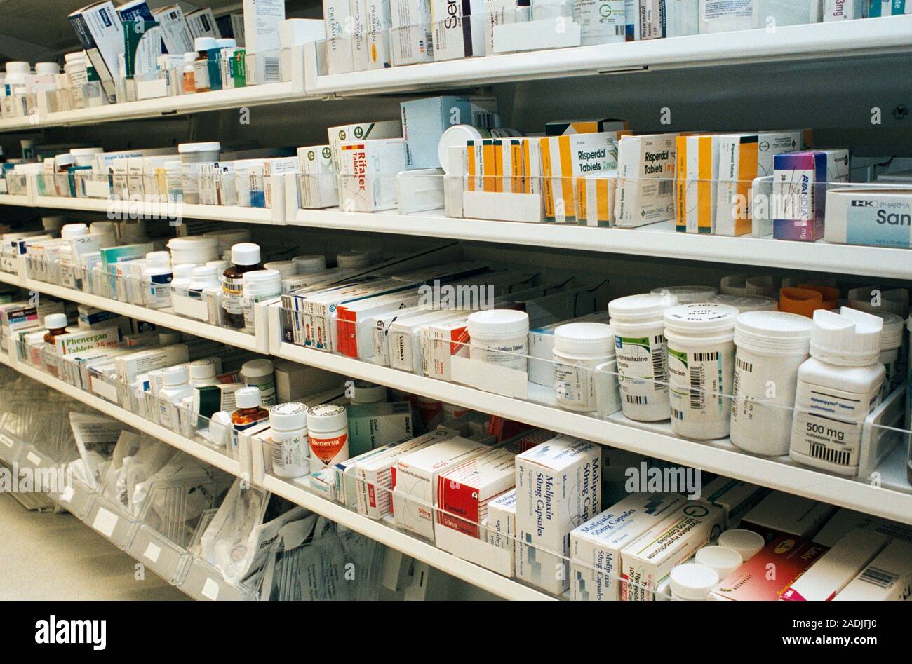 Pharmacy. Range of drugs stored on the shelves of a pharmacy store-room ...