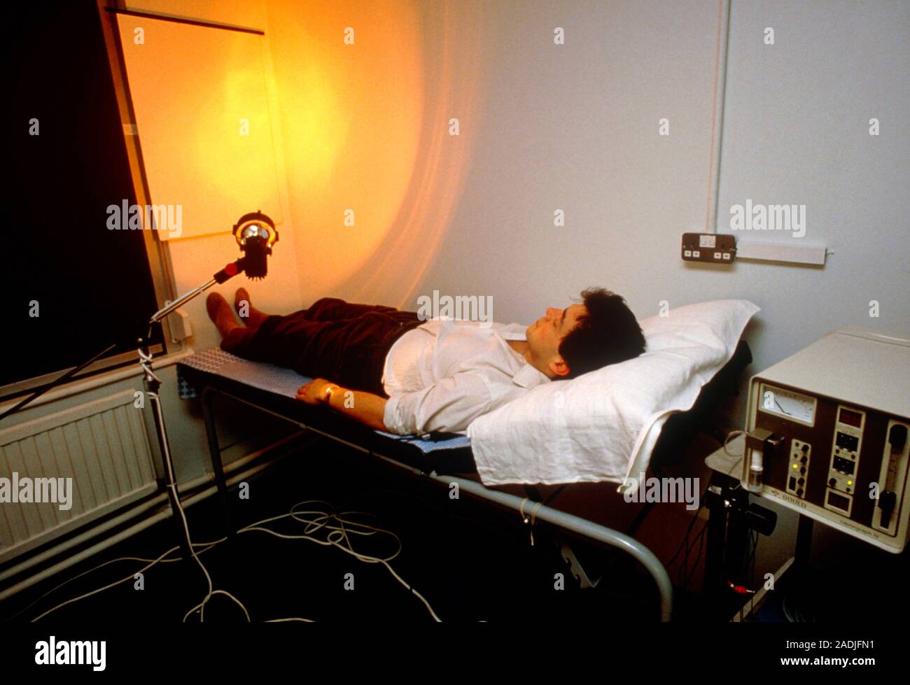 Man undergoing biofeedback therapy, showing him lying connected to ...
