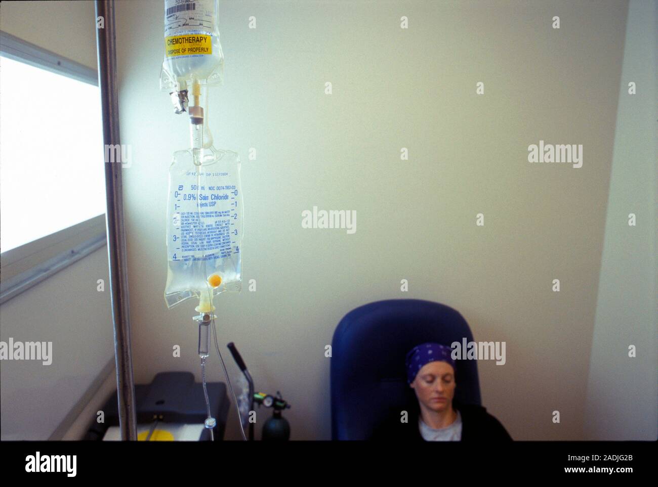 Cancer chemotherapy. Female patient receiving anticancer drugs from an ...