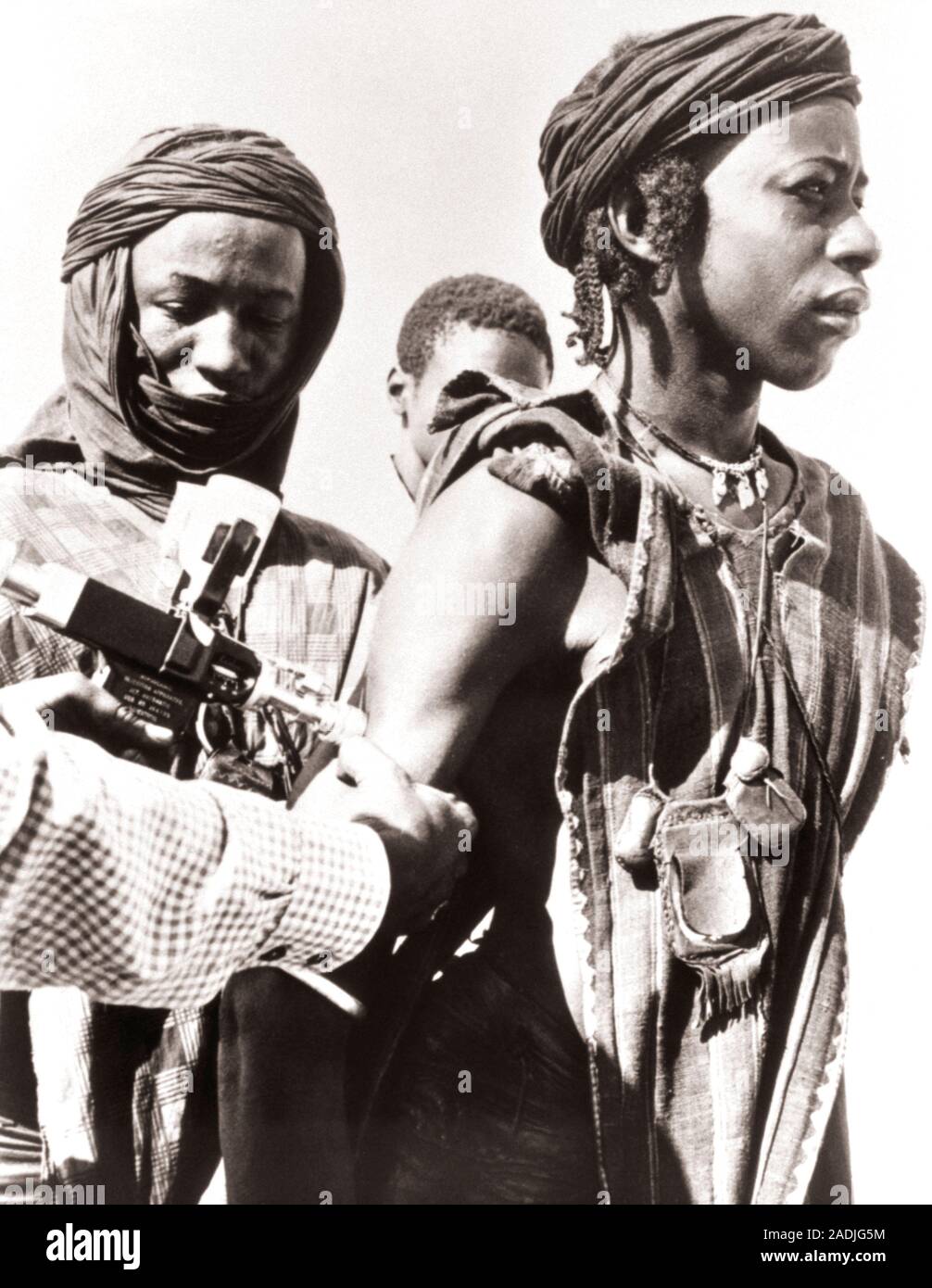 Immunization. Health worker injects smallpox vaccine with a vaccine gun ...