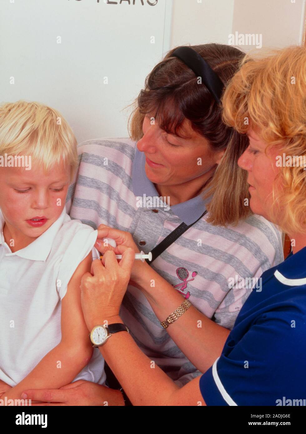 Pre-school DPT booster. A 4-year- old boy receives a pre-school booster ...