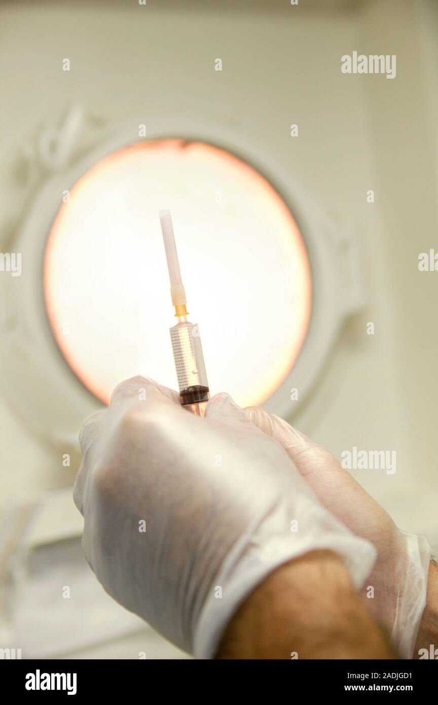 Injection. Ship's doctor preparing a syringe for an injection Stock ...