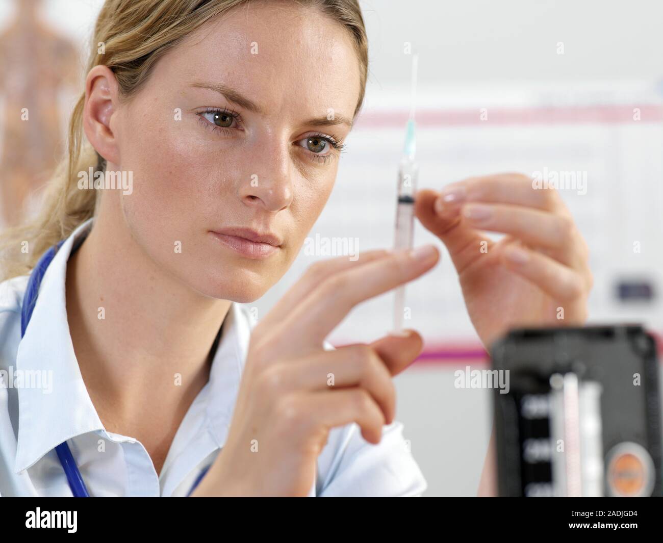 Injection preparation. Female GP preparing an injection Stock Photo - Alamy