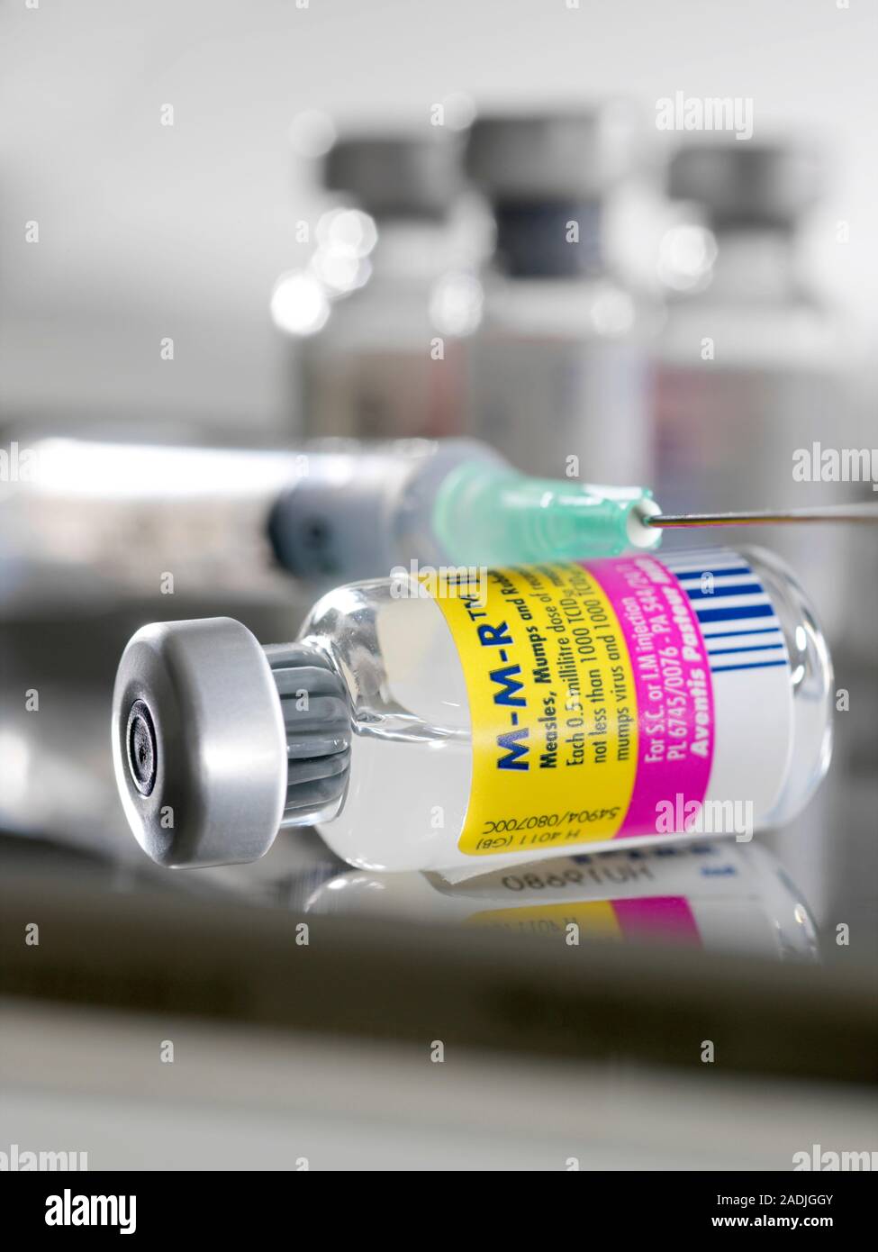 MMR vaccine. Syringe and vial on a counter. This combined vaccine ...