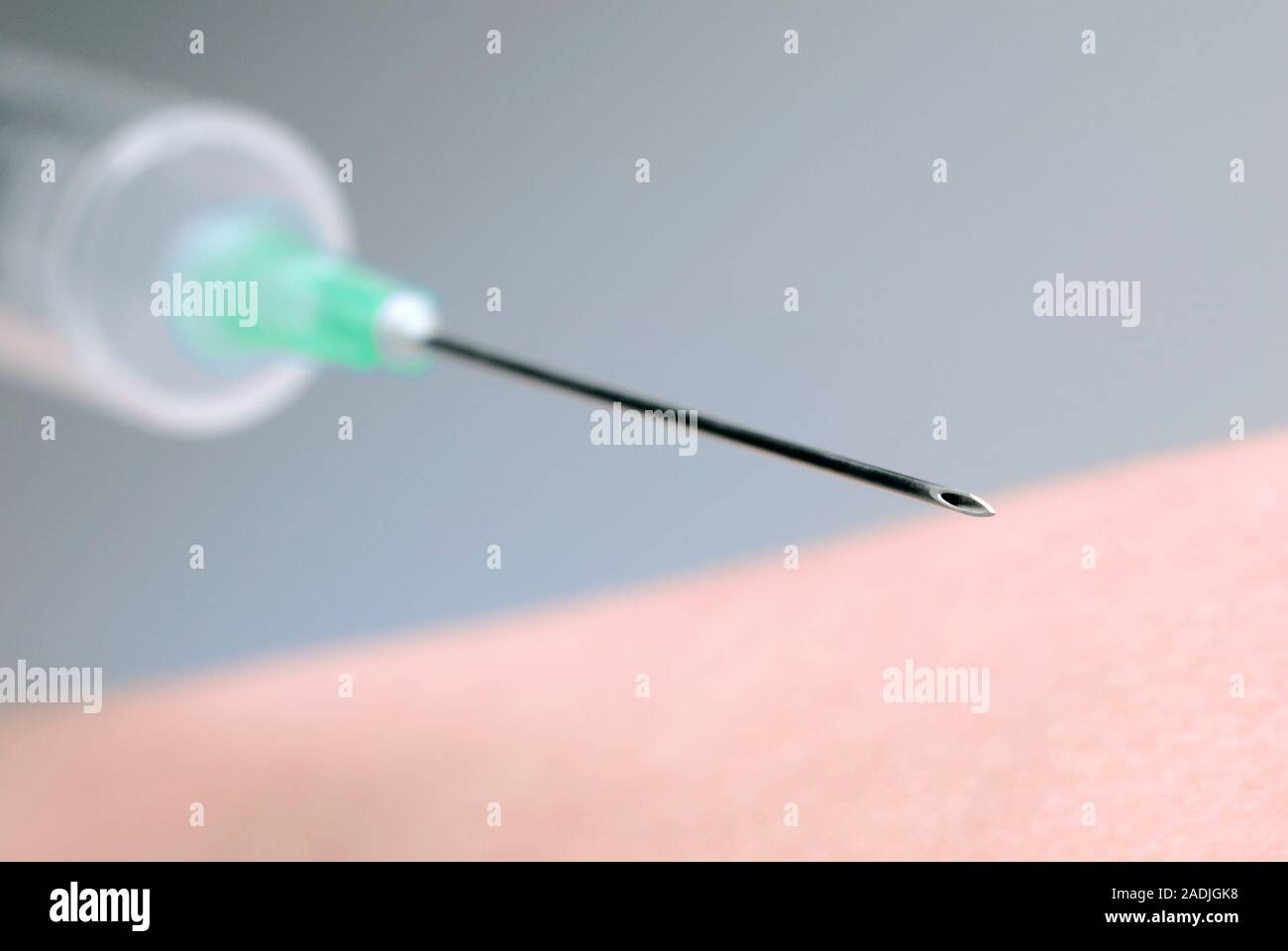 Injection. Hypodermic needle tip entering a patient's skin Stock Photo ...