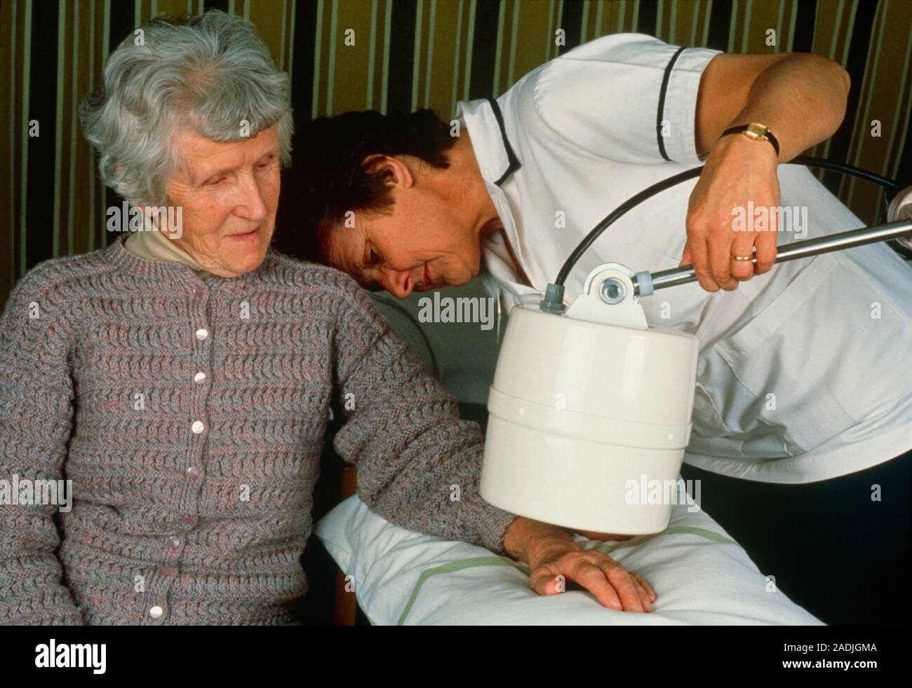 Physiotherapist using a pulsed shortwave diathermy device for pain ...