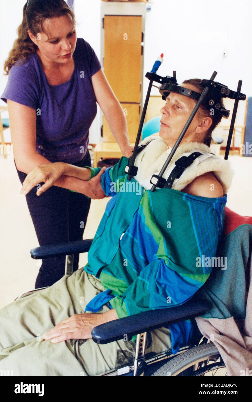 Rehabilitation therapy. Woman suffering from compression of the spinal ...