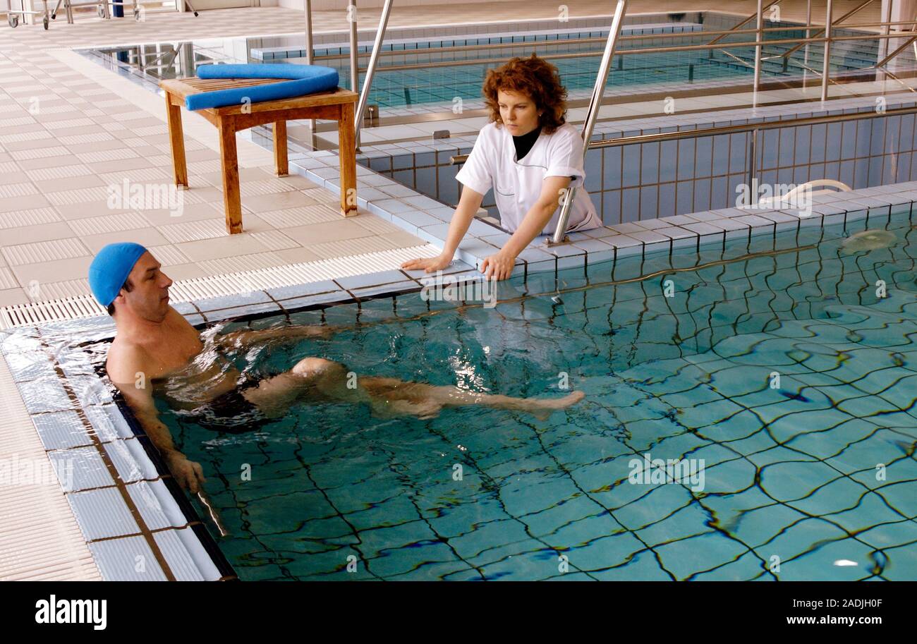 MODEL RELEASED. Hydrotherapy. Man doing exercises in a hydrotherapy ...