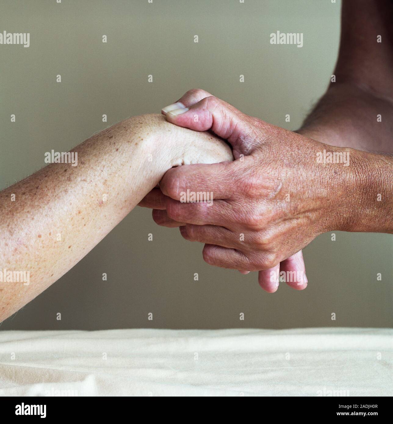 MODEL RELEASED. Physiotherapy. Physiotherapist manipulating the wrist ...