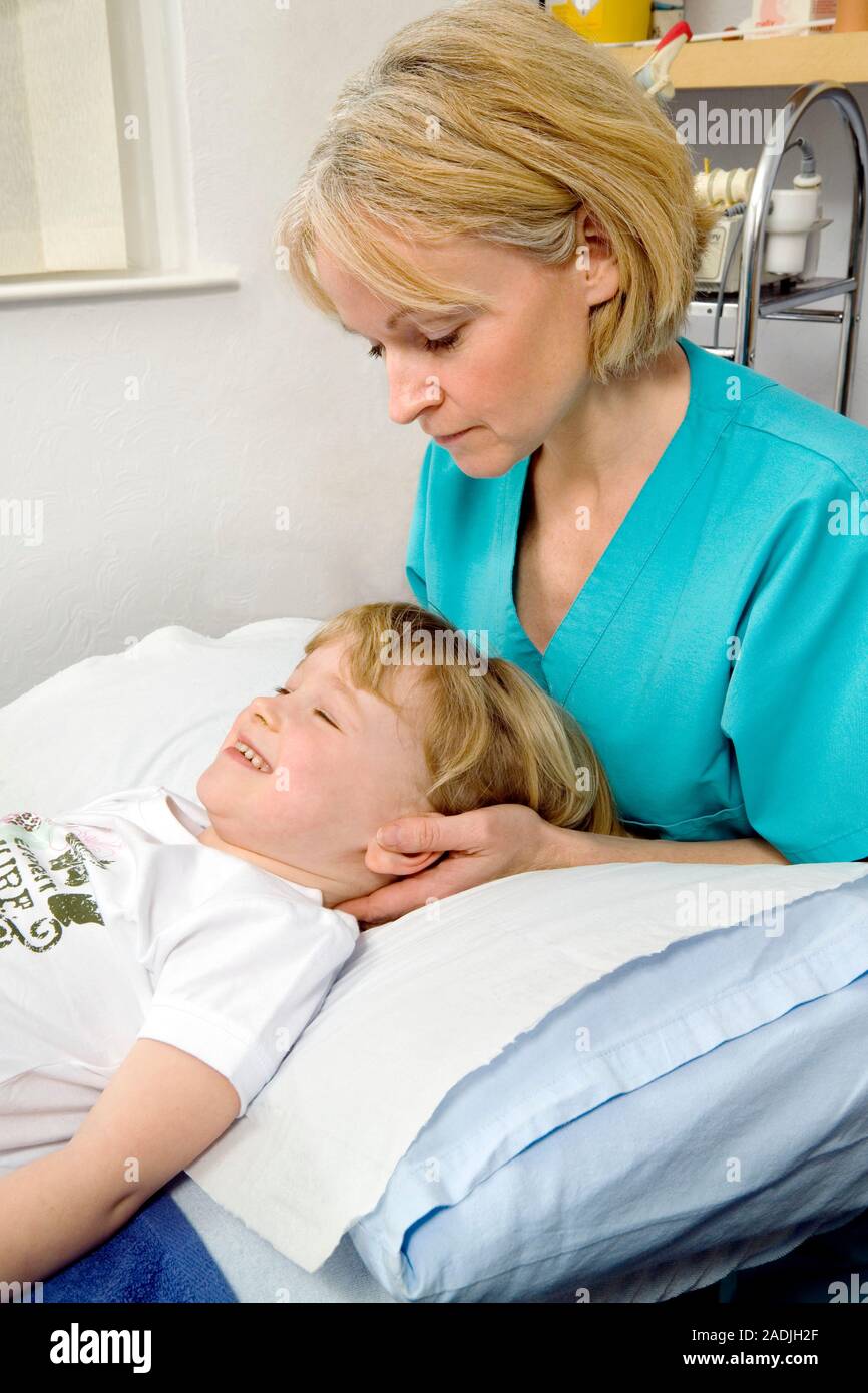 Cervical spine mobilisation treatment. Physiotherapist manipulating the ...