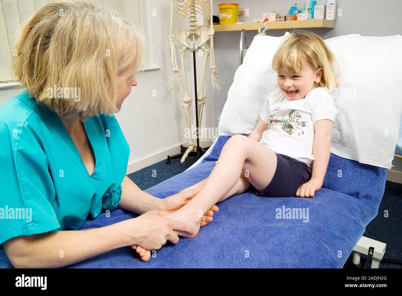 Foot and ankle examination. Physiotherapist preparing to perform a foot ...