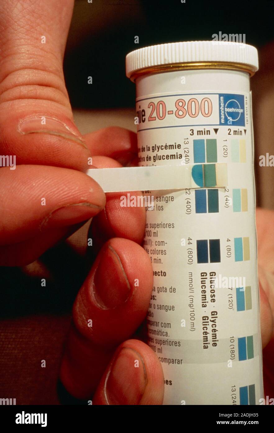 Placing test strip for measuring glucose in the blood against a ...