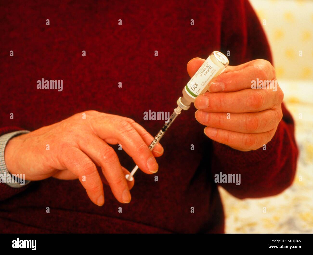 Human insulin: A diabetic fills a syringe with Ultratard, a human ...