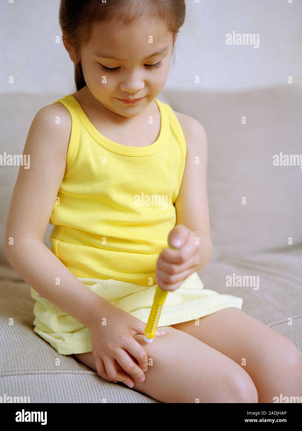 Insulin injection. Five-year-old girl with the condition diabetes ...