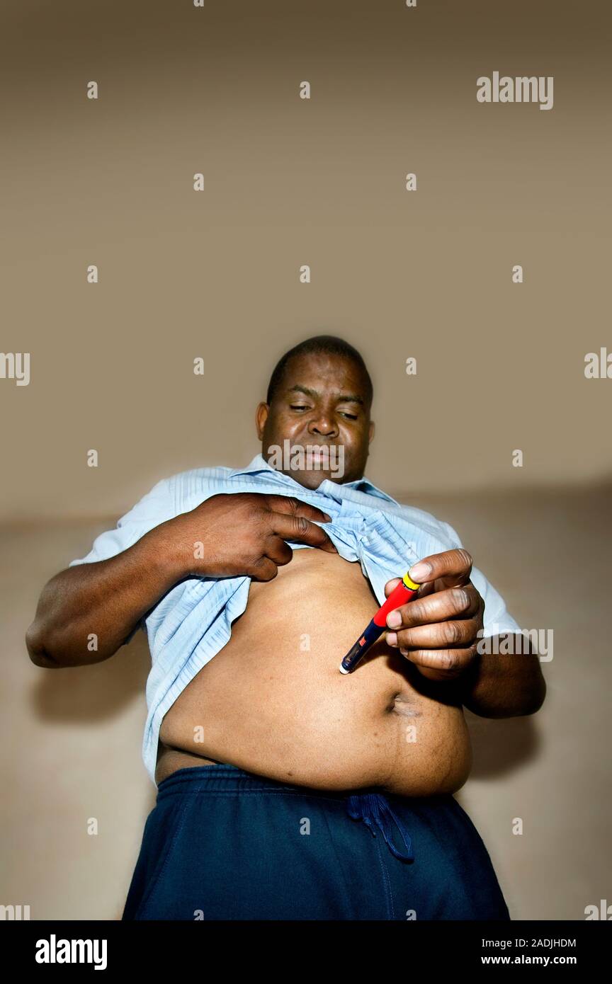 Diabetic man injecting himself with insulin in his home. Diabetes is a ...