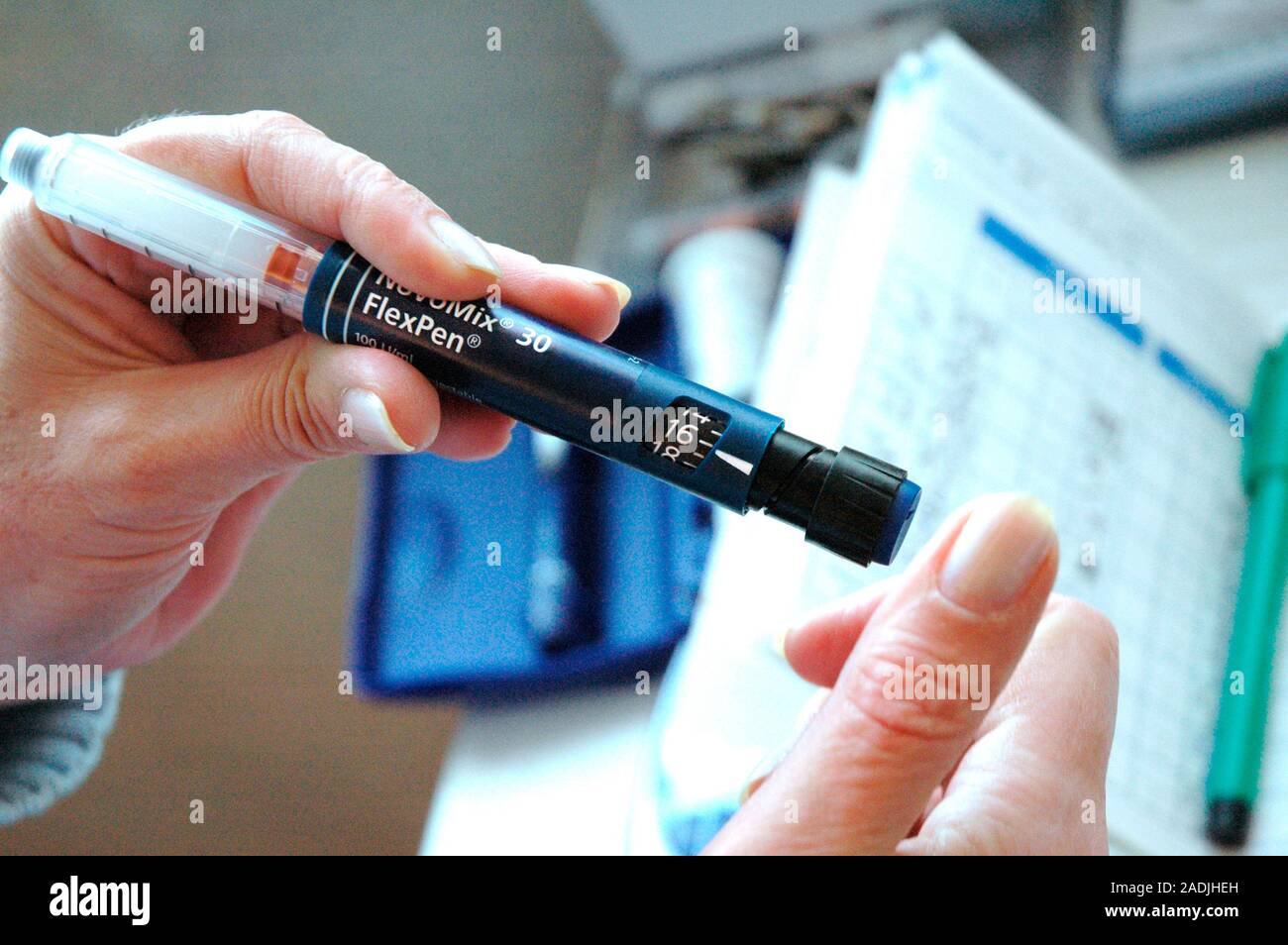 MODEL RELEASED. Insulin pen. Nurse preparing a flexpen, a pre-filled ...