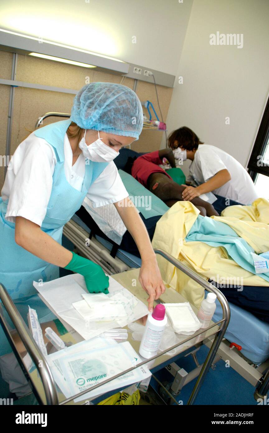 Dressing an ulcer. Hospital nurse dressing an ulcer on a 10-year-old ...