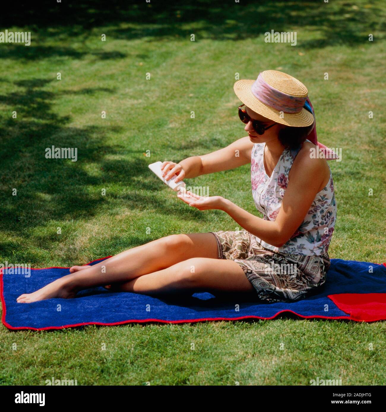 Model released. Young woman applying a sunscreen. Sunscreens are ...