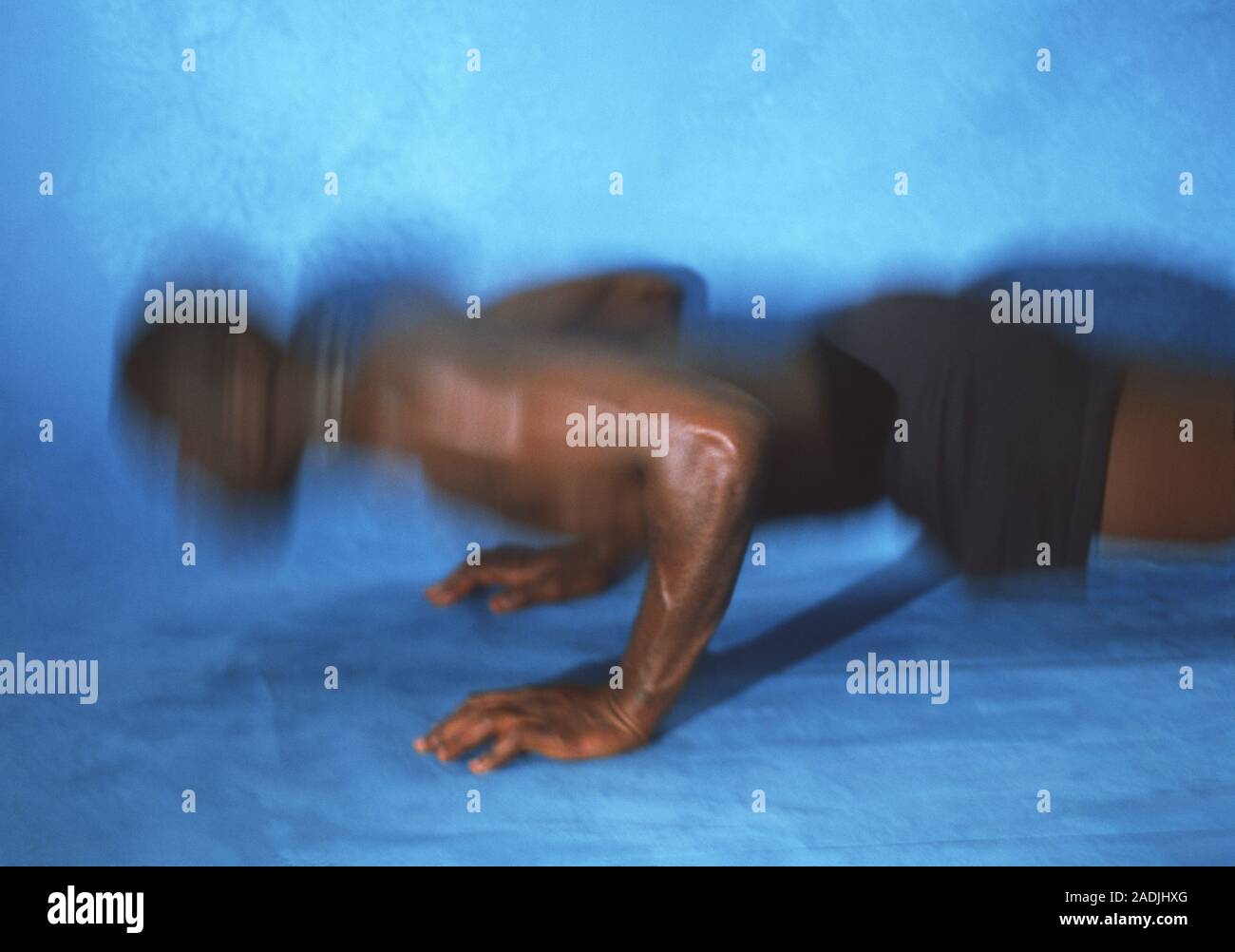 MODEL RELEASE. Press-ups. Image 1 of 2. Time- exposure image of young ...