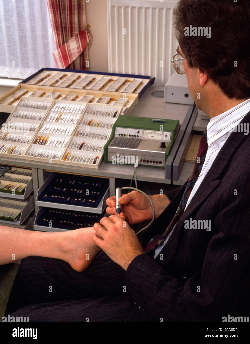 VEGA test for allergies. Homeo- path performs a VEGA test to diagnose ...