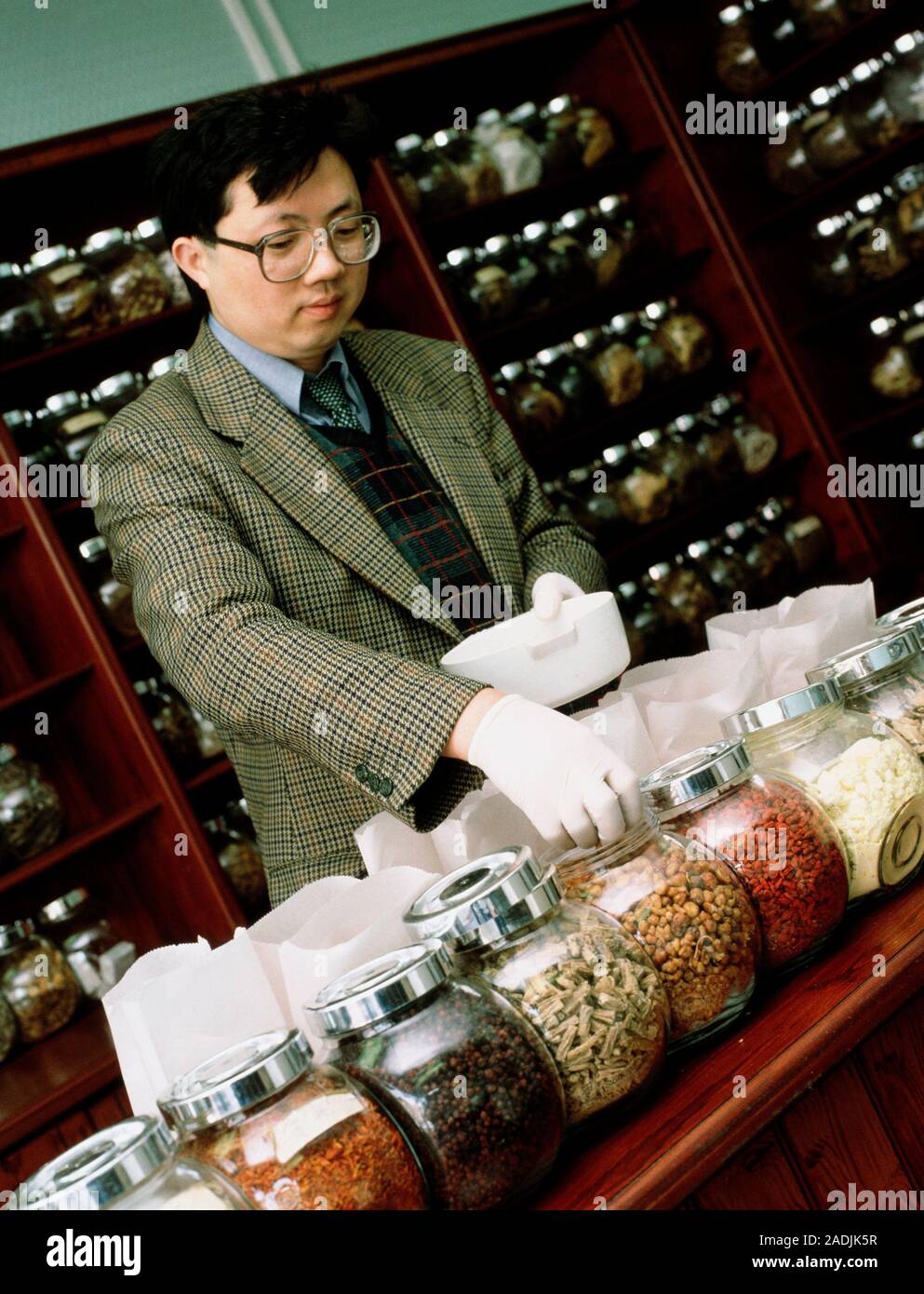 Chinese pharmacy. Herbalist dispenses medicine in a Chinese pharmacy ...