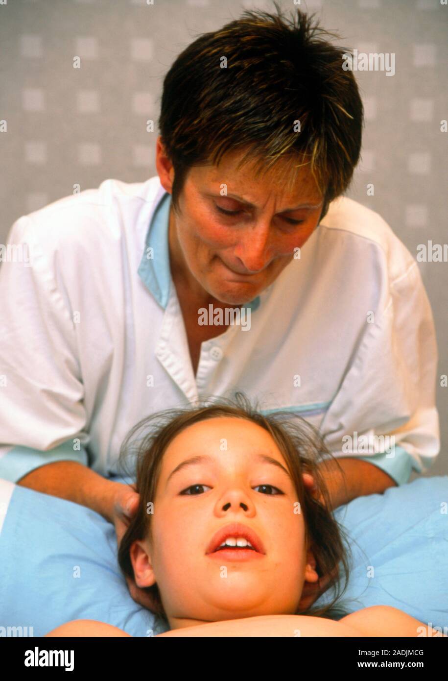 Osteopathy. Osteopath manipulating a 9-year-old girl's head. Osteopathy ...