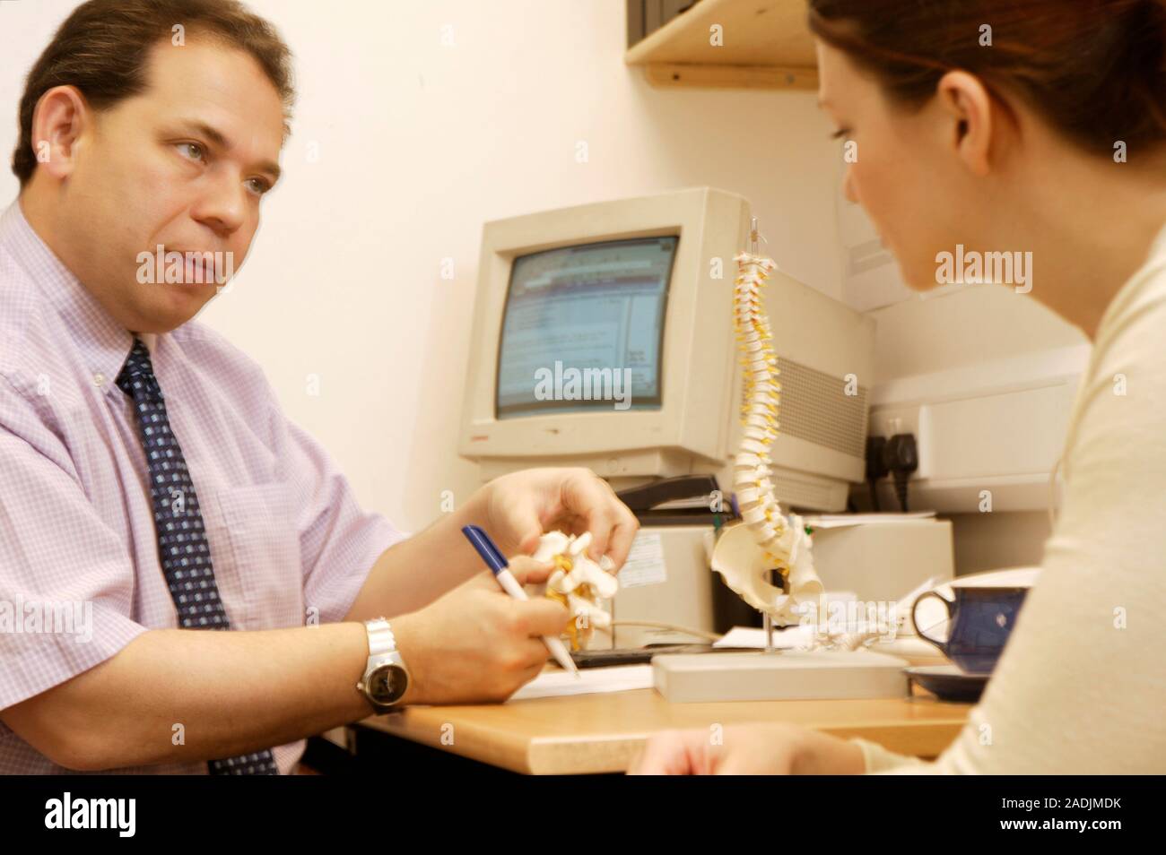 Osteopathy. Osteopath and female patient in a consultation room. The ...