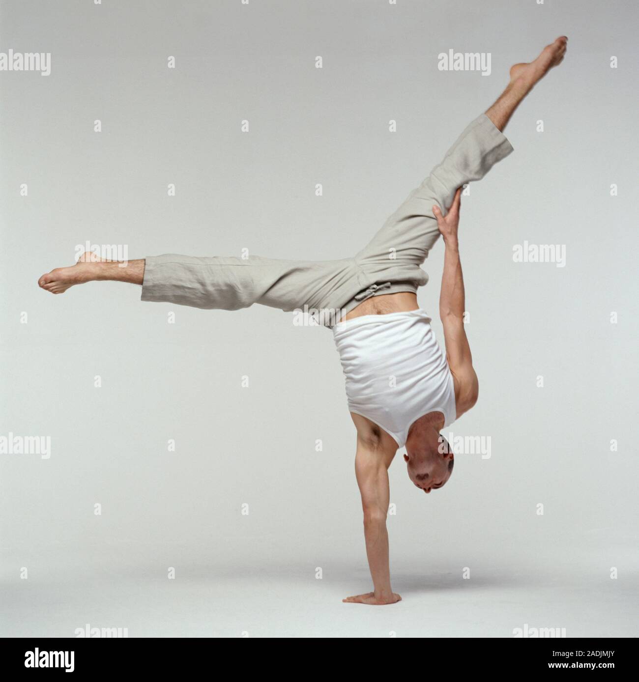 Yoga pose. Man performing a handstand as a yoga position Stock Photo ...