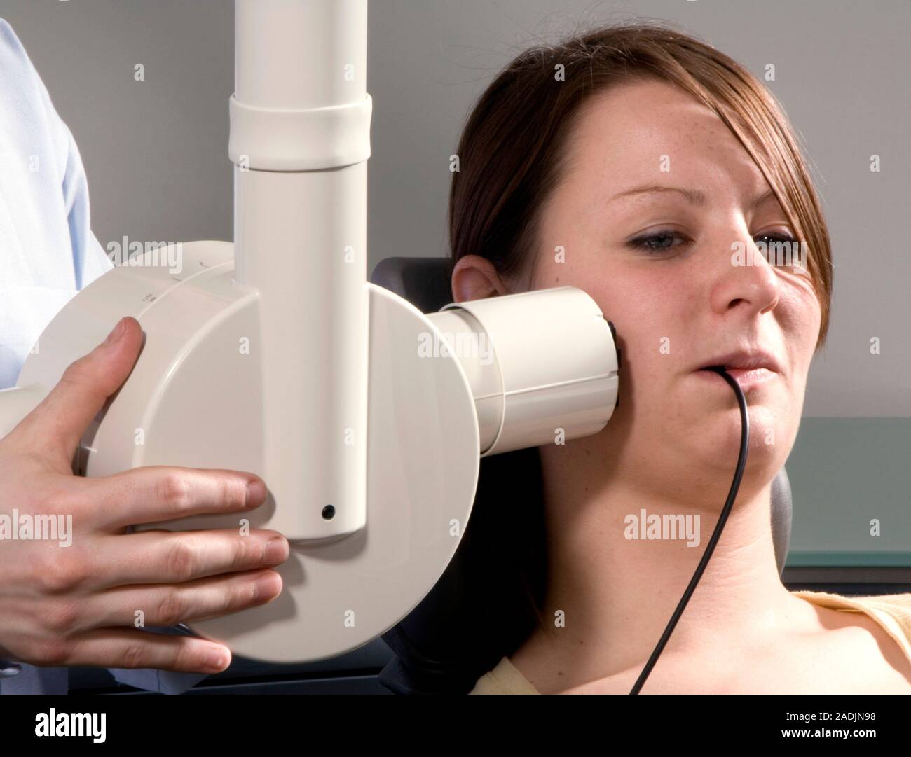 Taking a dental X-ray with a digital X-ray machine. The digital X-ray ...
