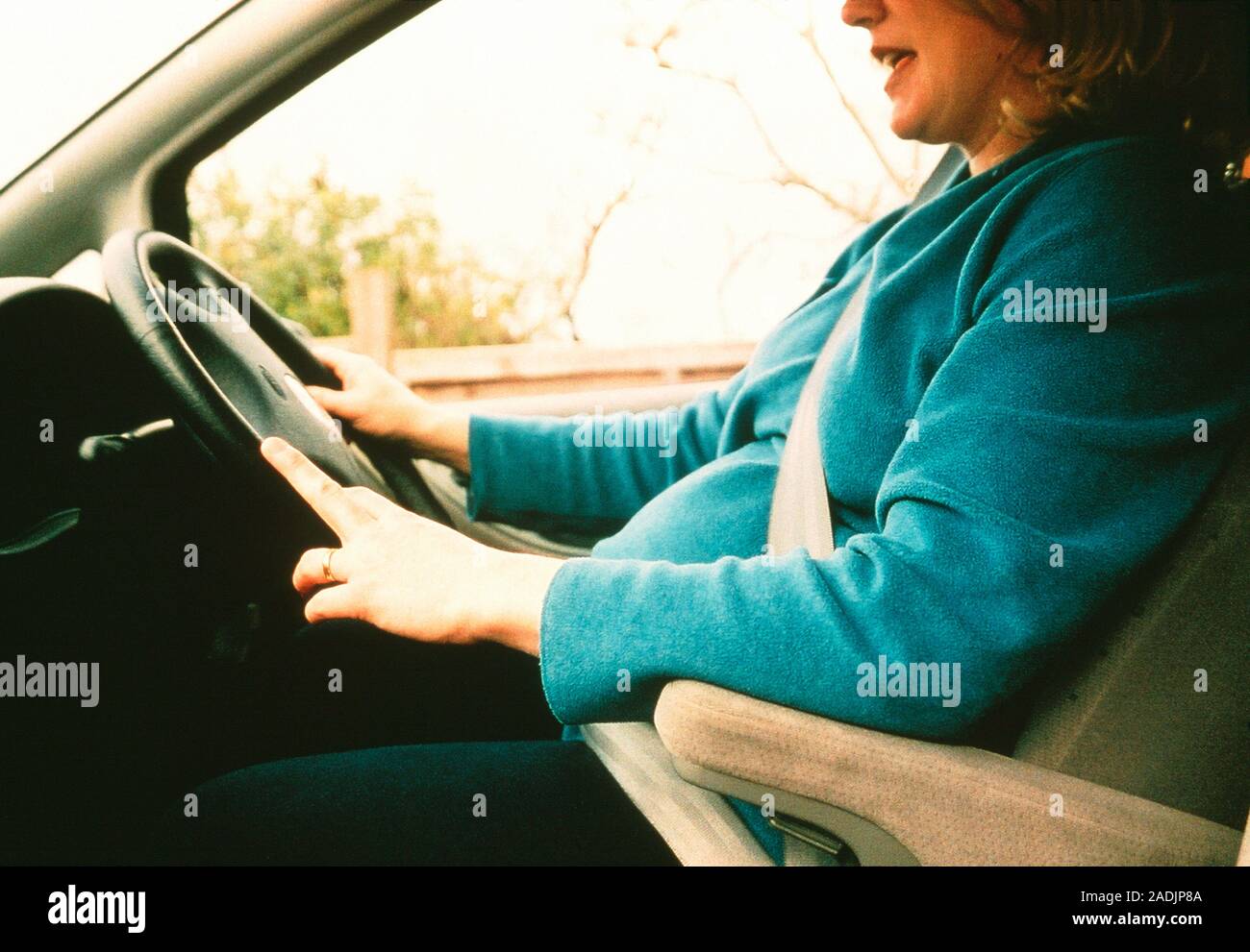 Pregnant pampering. Man painting the toenails of his pregnant partner ...