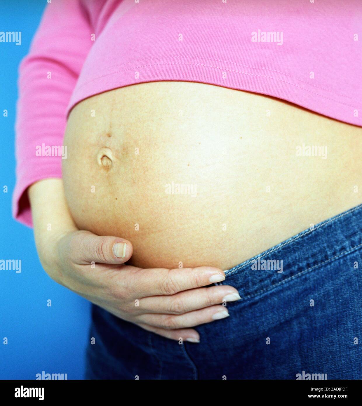 Pregnant Woman Holding Her Swollen Abdomen She Is 26 Weeks Pregnant A pregnant-woman-holding-her-swollen-abdomen-she-is-26-weeks-pregnant-a