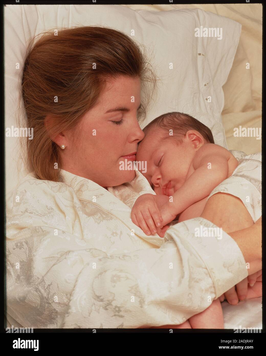 Mother and child. Healthy newborn baby being cradled by its mother in ...