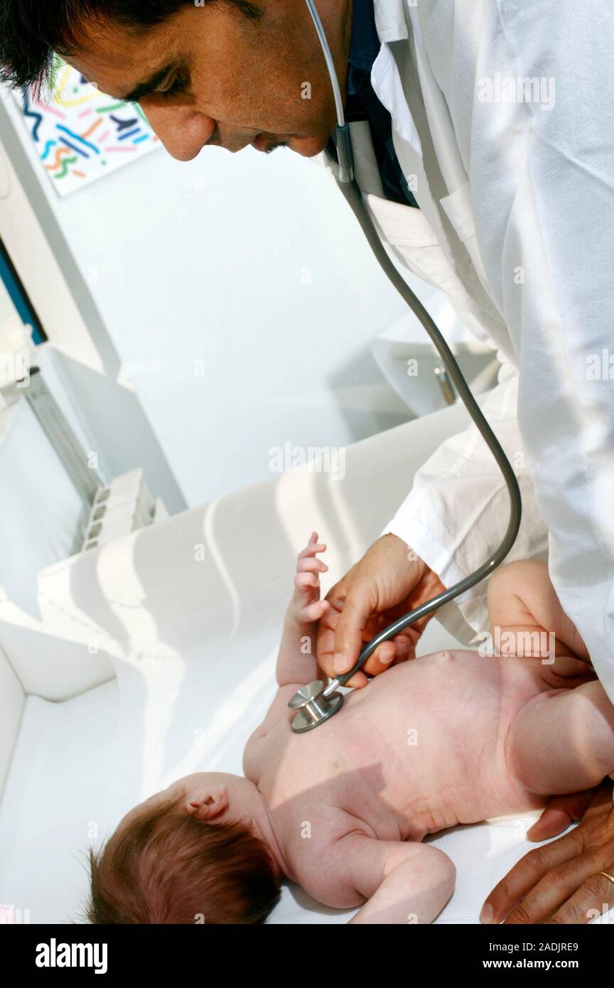 Neonatal examination. Doctor using a stethoscope to listen to a newborn ...