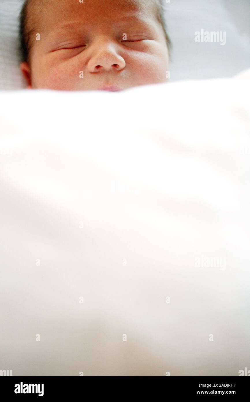 Newborn baby sleeping in a cot Stock Photo - Alamy