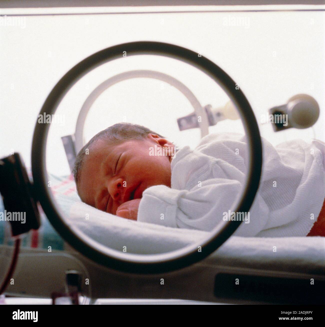 Baby in incubator. View of a newborn baby in an incubator. An incubator ...