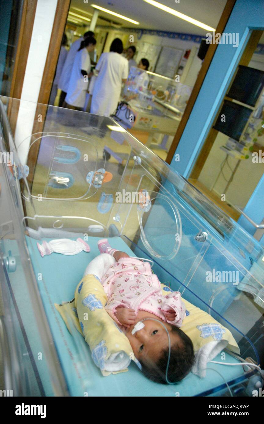 MODEL RELEASED. Premature baby in an incubator. Incubators provide a ...