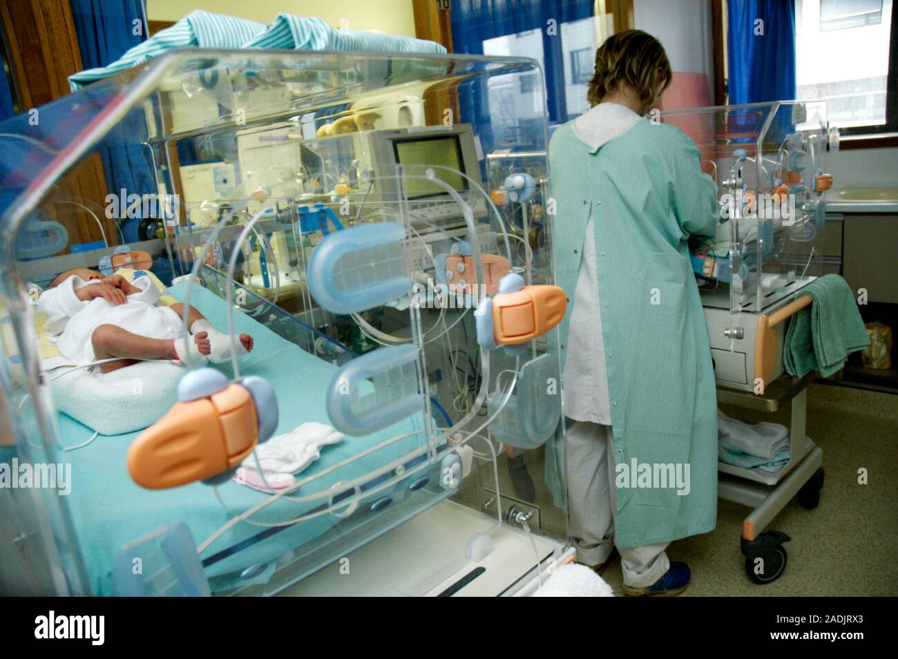 MODEL RELEASED. Premature babies. Nurse attending a premature baby in ...