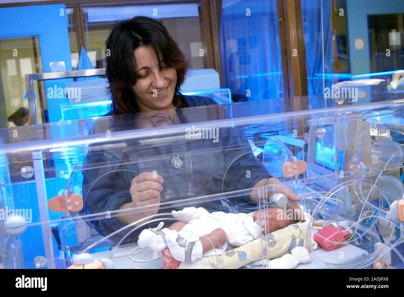 Mother with her premature baby. Incubators provide a warm, moist ...