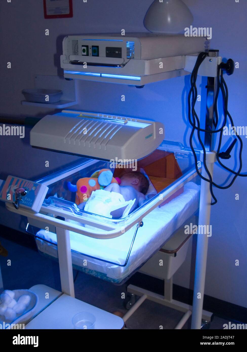 Neonatal jaundice treatment. Baby in an incubator receiving blue light ... Neonatal jaundice treatment. Baby in an incubator receiving blue light ...