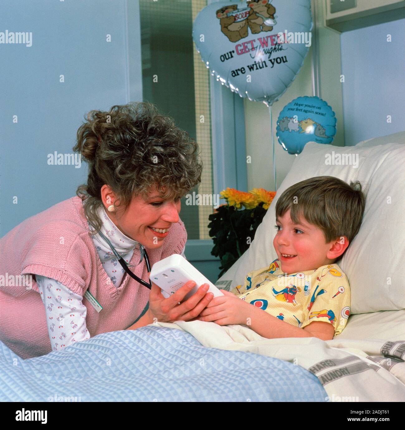 MODEL RELEASE AVAILABLE: A pediatric nurse with a young patient in ...